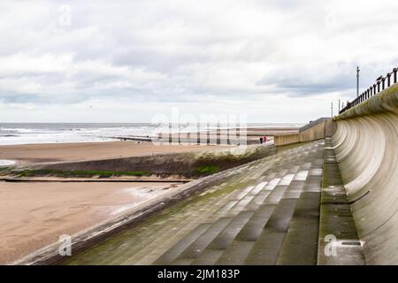 Concrete concave sea wall Stock Photo - Alamy