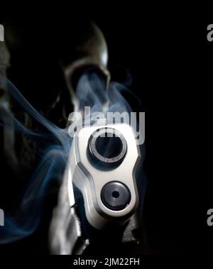 Smoking barrel of a semi-automatic gun on black Stock Photo - Alamy