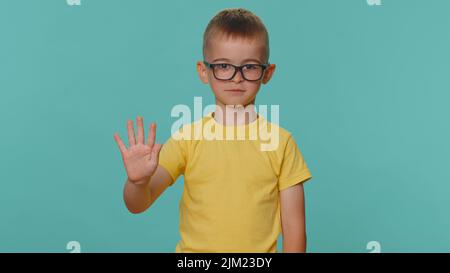 Stop gesture. Angry young preteen child girl kid say No hold palm ...