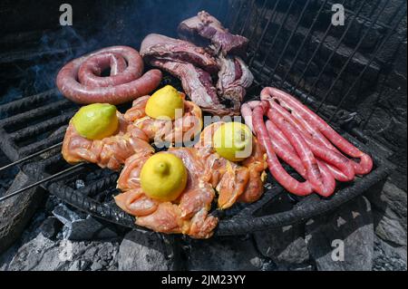 Typical Uruguayan and Argentine Asado Cooked on fire. Entrana and Vacio ...