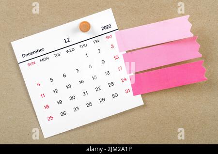 The December 2022 calendar with blank adhesive note paper on brown ...