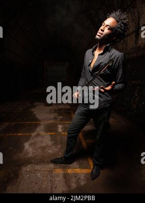 Dark Threat. A menacing character emerging from the shadows wielding a ...