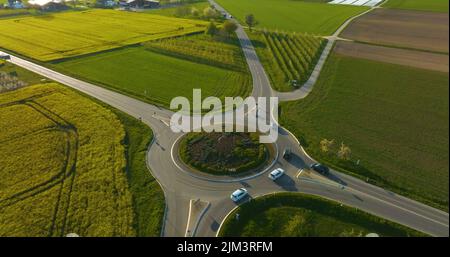 The roundabout with cars surrounded by greenery in Germany Stock Photo ...