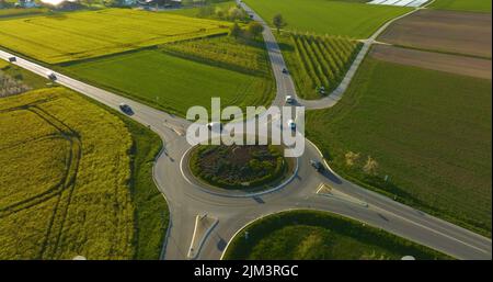 The roundabout with cars surrounded by greenery in Germany Stock Photo ...