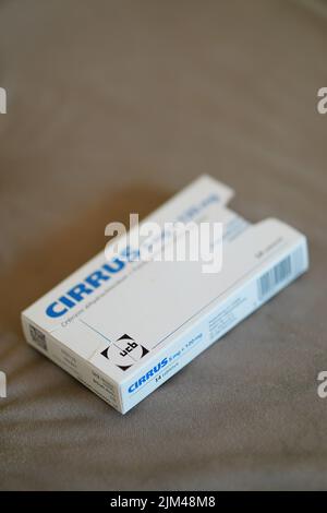 A closeup of Cirrus brand medicine as pills against full nose in a box ...