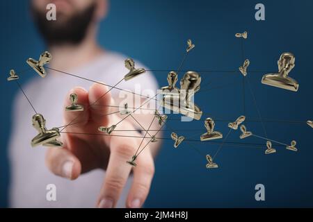 A closeup of illustrated people icons near a hand Stock Photo - Alamy
