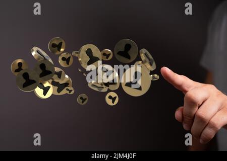 A closeup of illustrated people icons near a hand Stock Photo - Alamy