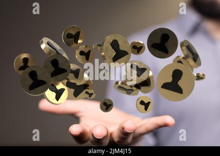 A closeup of illustrated people icons near a hand Stock Photo - Alamy