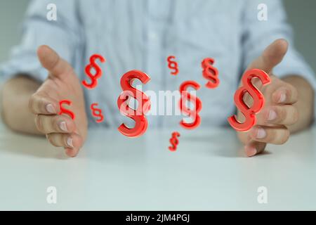 A closeup of illustrated Law Protection Right Symbols near a hand Stock ...