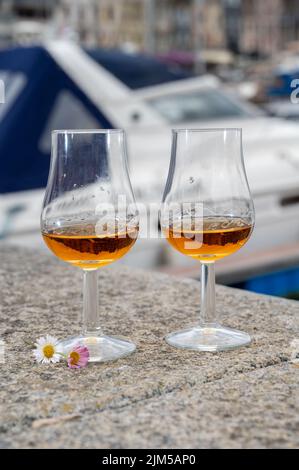 Tasting of apple calvados drink from glasses in old Honfleur harbour ...