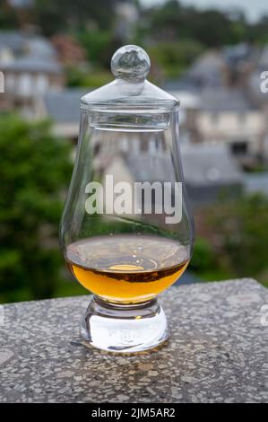 Dram of scotch whiskey with view on old houses on background, Edinburgh ...