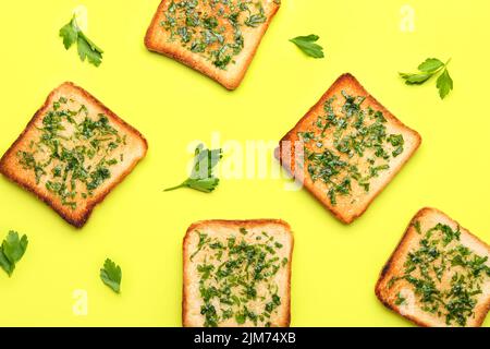 Composition with slices of toasted garlic bread and parsley on color ...