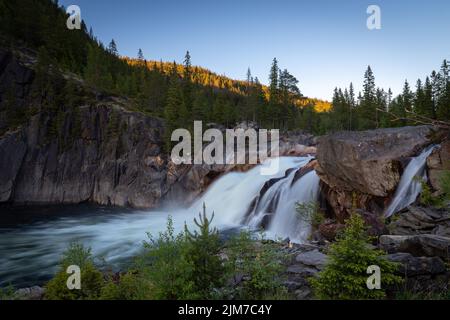 Hyttfossen waterfall during sunset time. Long exposure time on flowing ...