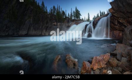 Hyttfossen waterfall during sunset time. Long exposure time on flowing ...