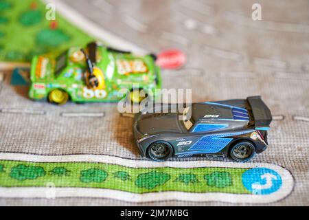 The Mattel toy model cars from the Disney Pixar Cars movie on a playmat ...