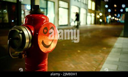 A closeup of a fire hydrant with a happy smile Stock Photo - Alamy