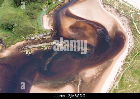Aerial of the mouth of the Fintragh river at Fintra beach by Killybegs ...