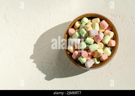 Multicolored marshmallows background. Mini powder cover candies. White ...