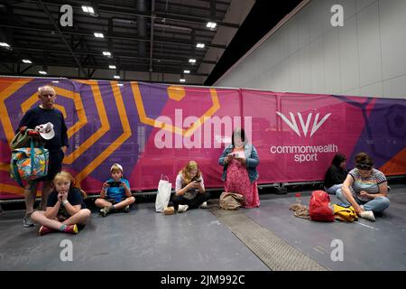 Spectators are held outside during a delay in play to inspect a health ...