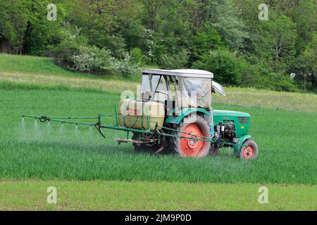 Old tractor with field syringe Stock Photo - Alamy