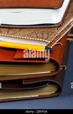 Pile of notebooks in leather covers and a pencil close up Stock Photo ...