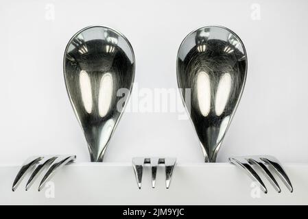 Two figures made of spoons and forks Stock Photo - Alamy