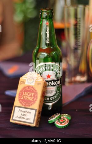 Box of Lucky Strike cigarettes without additives in front of a Heineken ...