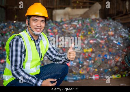 A workers work on recycle waste, Recycling Analyst looking at recycling ...