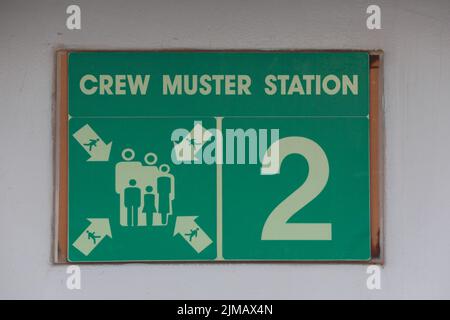 Crew muster station sign on a cruise ship open deck Stock Photo - Alamy