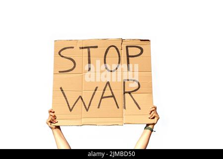 A Cardboard Signs saying Stop War held by hands on a white background ...