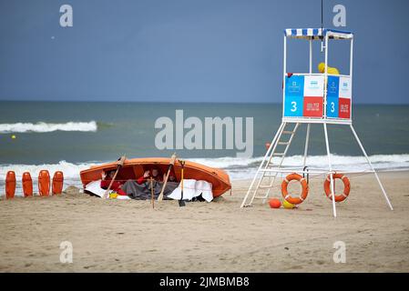 lifeguards hide in the lifeboat during a storm on the beach Stock Photo ...