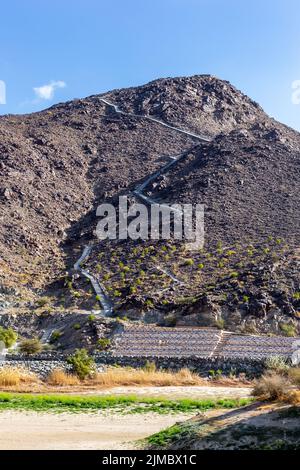 Wadi Shawka hiking trail, winding gravel dirt road through Wadi Shawka ...