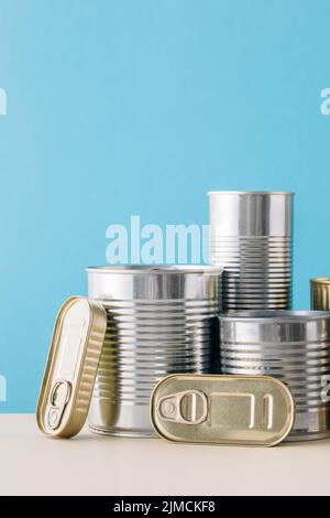 Stacked unopened metal cans on grey background Stock Photo - Alamy
