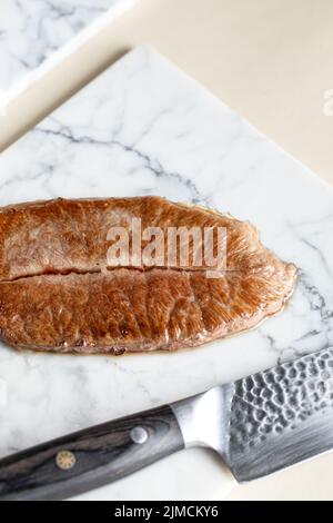 From above of tasty kobe prefecture wagyu beef served on marble cutting ...