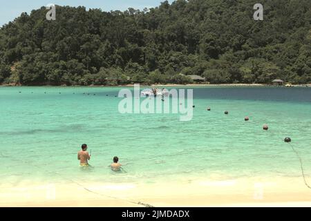 Visitors having recreational time on the beach of Pulau Sapi (Sapi ...