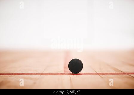 Ill be bouncing around in no time. a squash ball on the floor of a ...