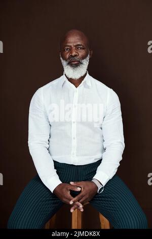 Studio shot of man against brown background Stock Photo - Alamy