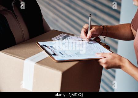 Woman signing for parcel delivery, closeup Stock Photo - Alamy