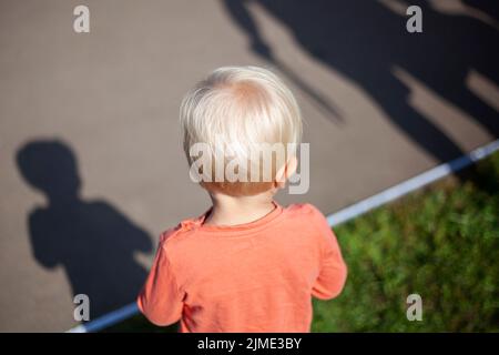 The child was lost in the crowd. A crowd of wooden figures of people ...