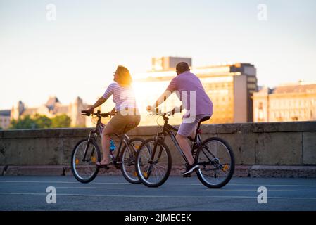 People ride bikes in the sun in London, Tuesday, June 23, 2026, as a ...