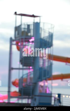 Blur On the open deck of a cruise ship on a calm day, with the coast in ...