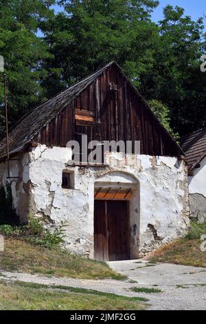 Austria, barn and old wine cellar built into the mountainside in the ...
