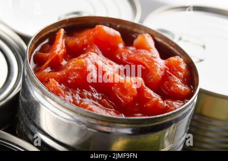 Canned sliced tomatoes in just opened tin can. Non-perishable food ...