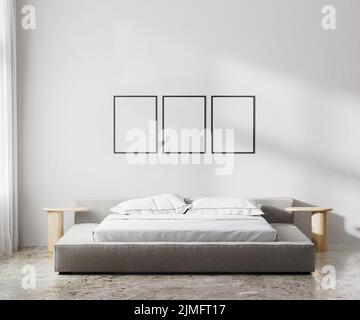 A 3D render of blank picture frames on a gray wall with copy space near ...