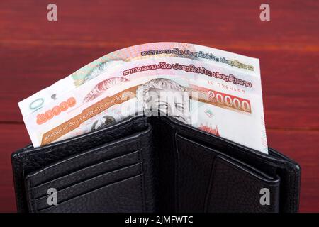 Lao money - kip in the black wallet Stock Photo - Alamy
