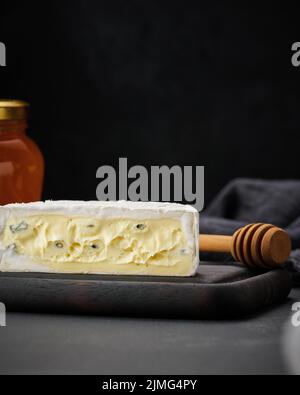 Bergader blue cheese on a brown wooden board, delicious snack Stock ...