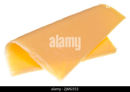 Folded thin slice of yellow cheese on top of a stack of yellow cheese ...