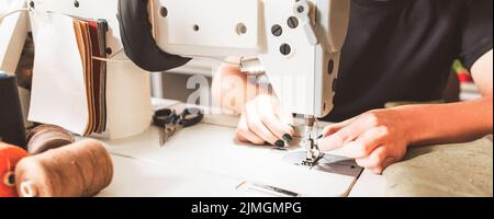 Female tailor threading sewing machine, closeup Stock Photo - Alamy