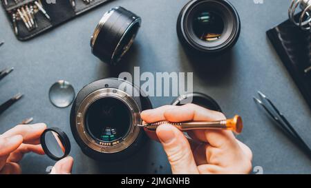 Disassembled device analysis. Top view of man hands repairing photo ...