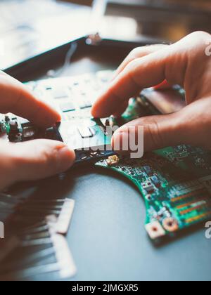 Electronic engineer installing microprocessor. Maintenance computer cpu hardware. Hand holding a ...